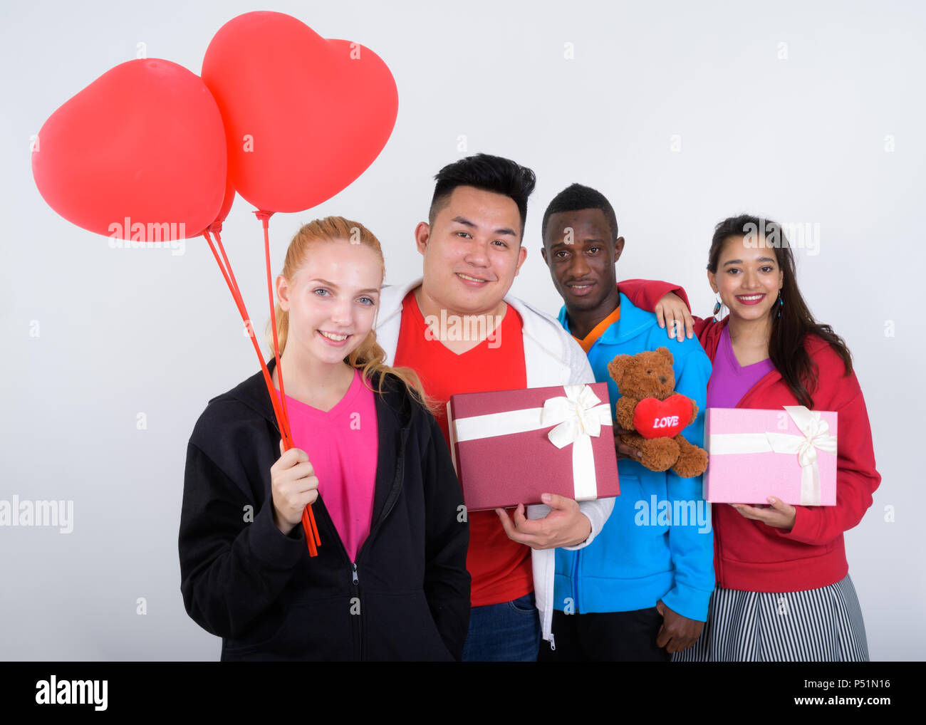 Happy diverse group of multi ethnic friends smiling while holdin Stock ...