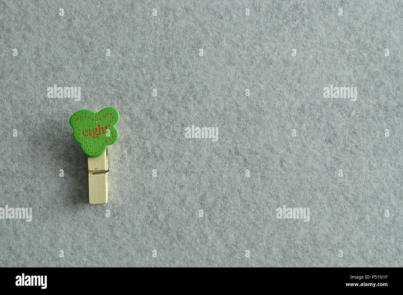 The word eight on a colorful peg on a white background Stock Photo - Alamy