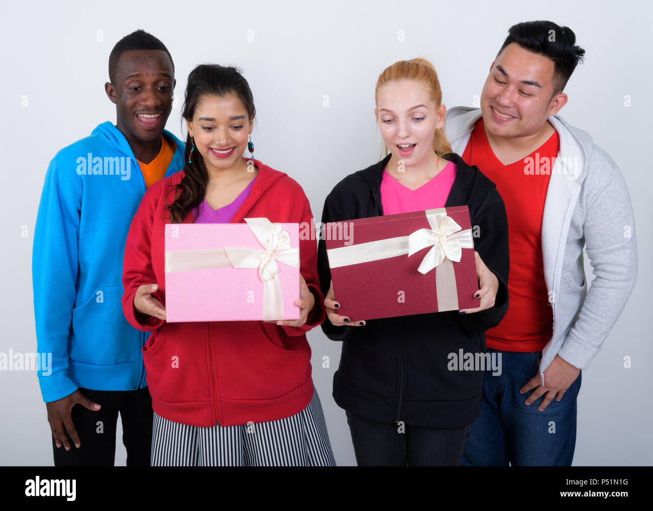 Happy diverse group of multi ethnic friends smiling while openin Stock ...