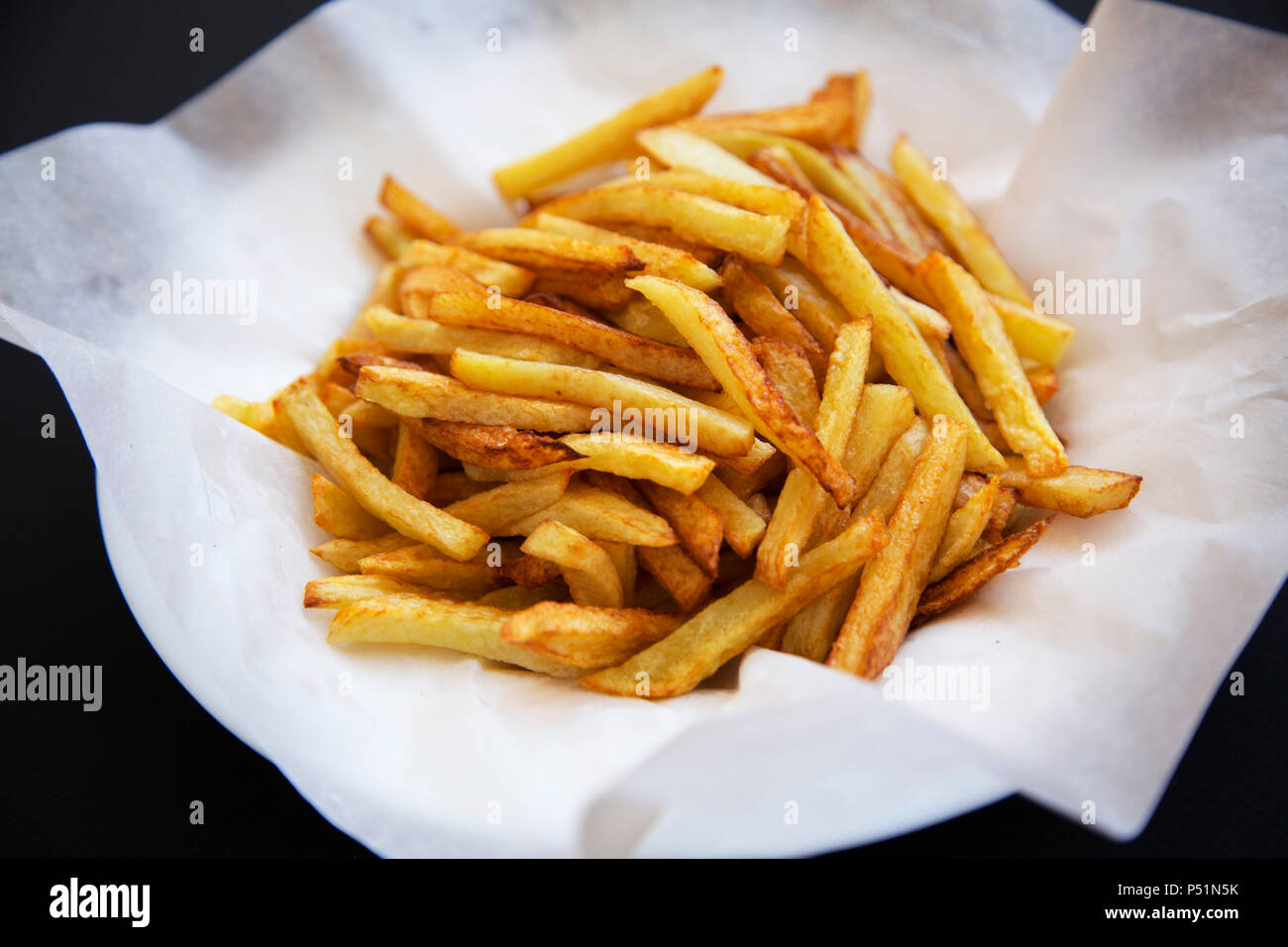 Plate of french fries on dark background, side view, close up Stock ...