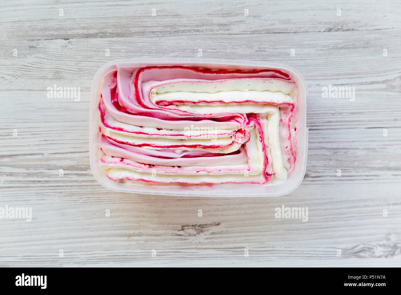 Ice cream in a plastic box on a white wooden table. Top view Stock ...