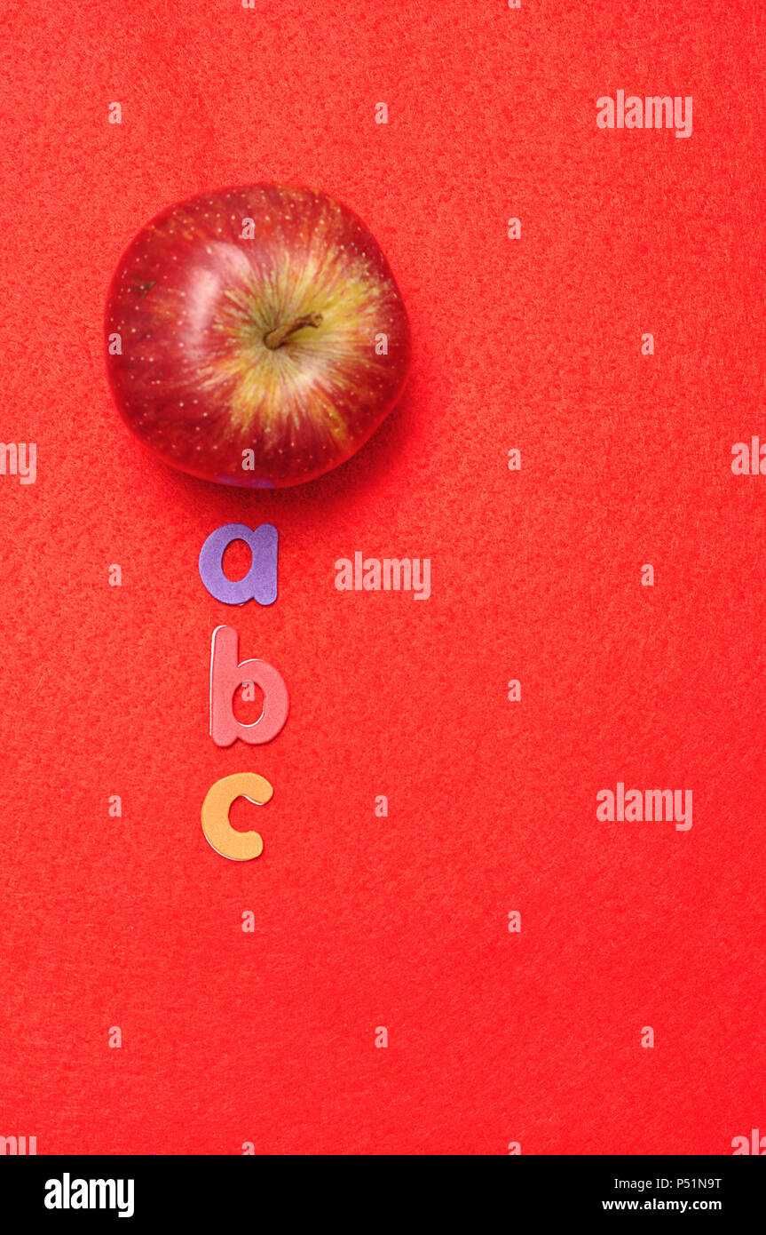 An apple displayed with abc on a red background Stock Photo - Alamy