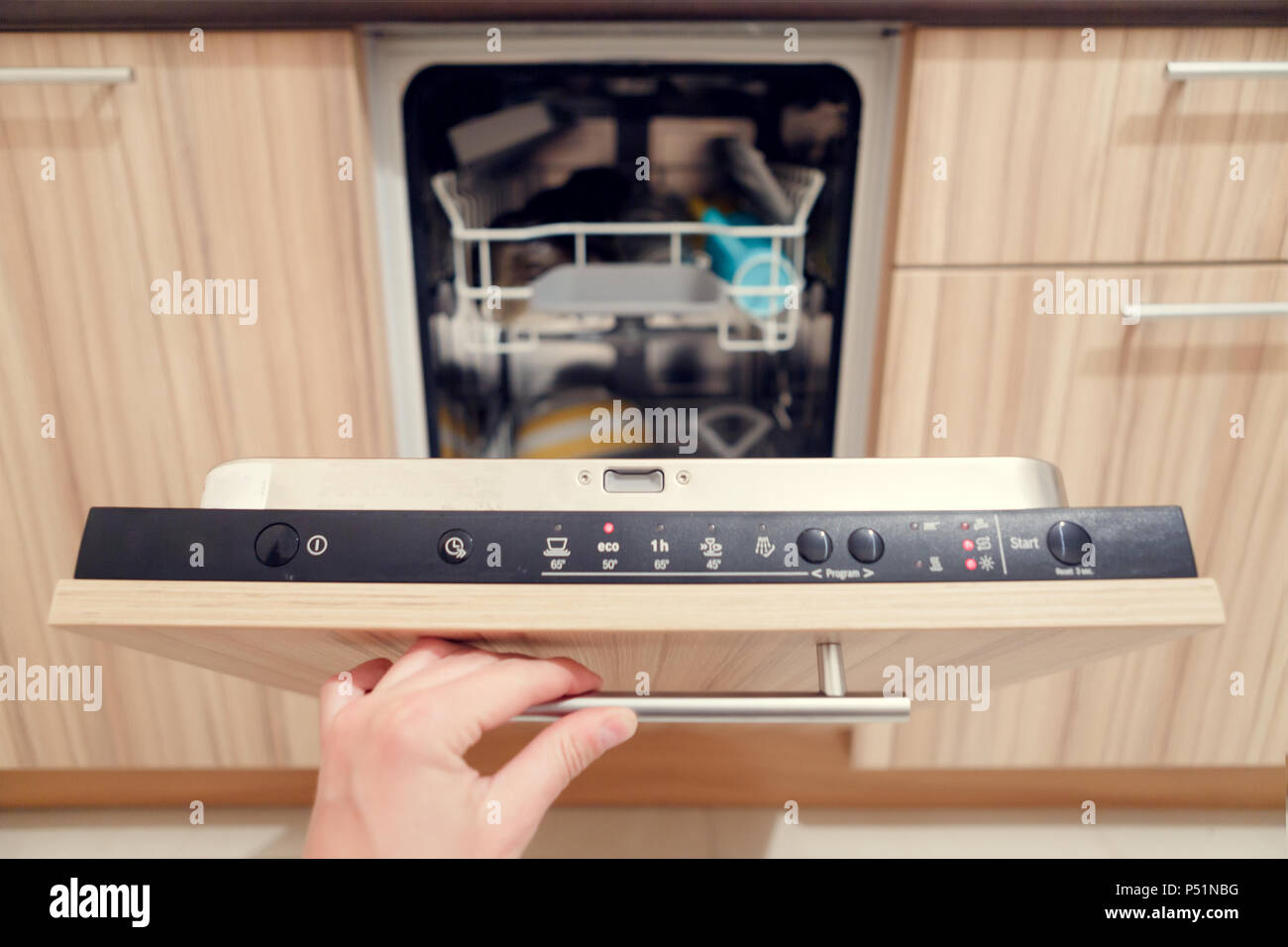 Photo of human's hand opening dishwasher with dirty dishes Stock Photo ...