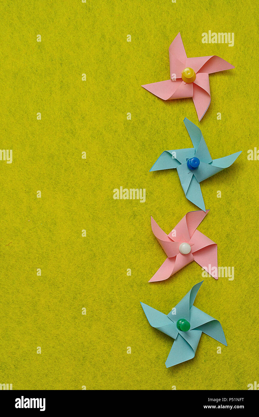 Blue and pink pinwheels displayed on a yellow background Stock Photo ...
