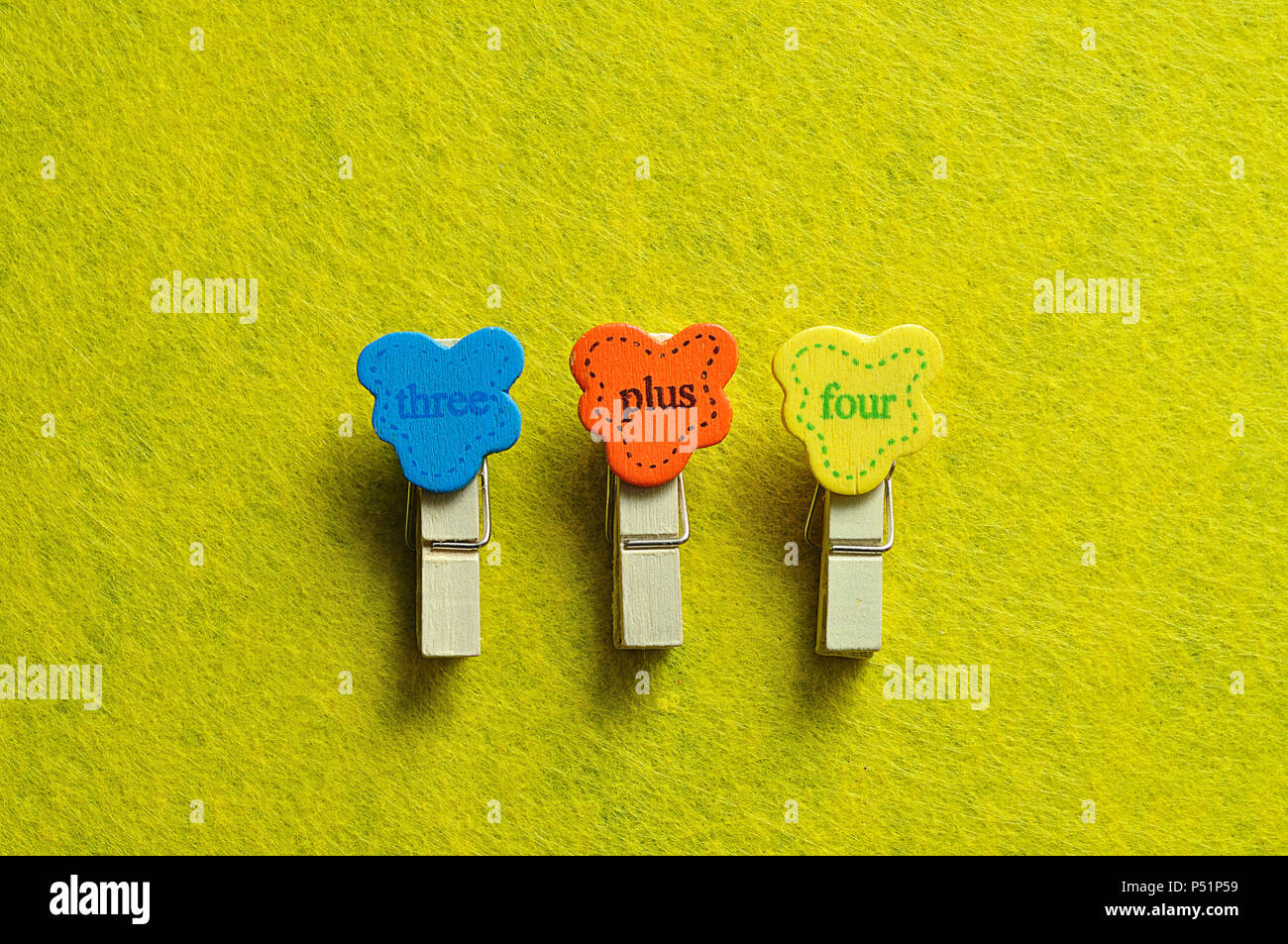 Three plus four on a yellow background Stock Photo - Alamy