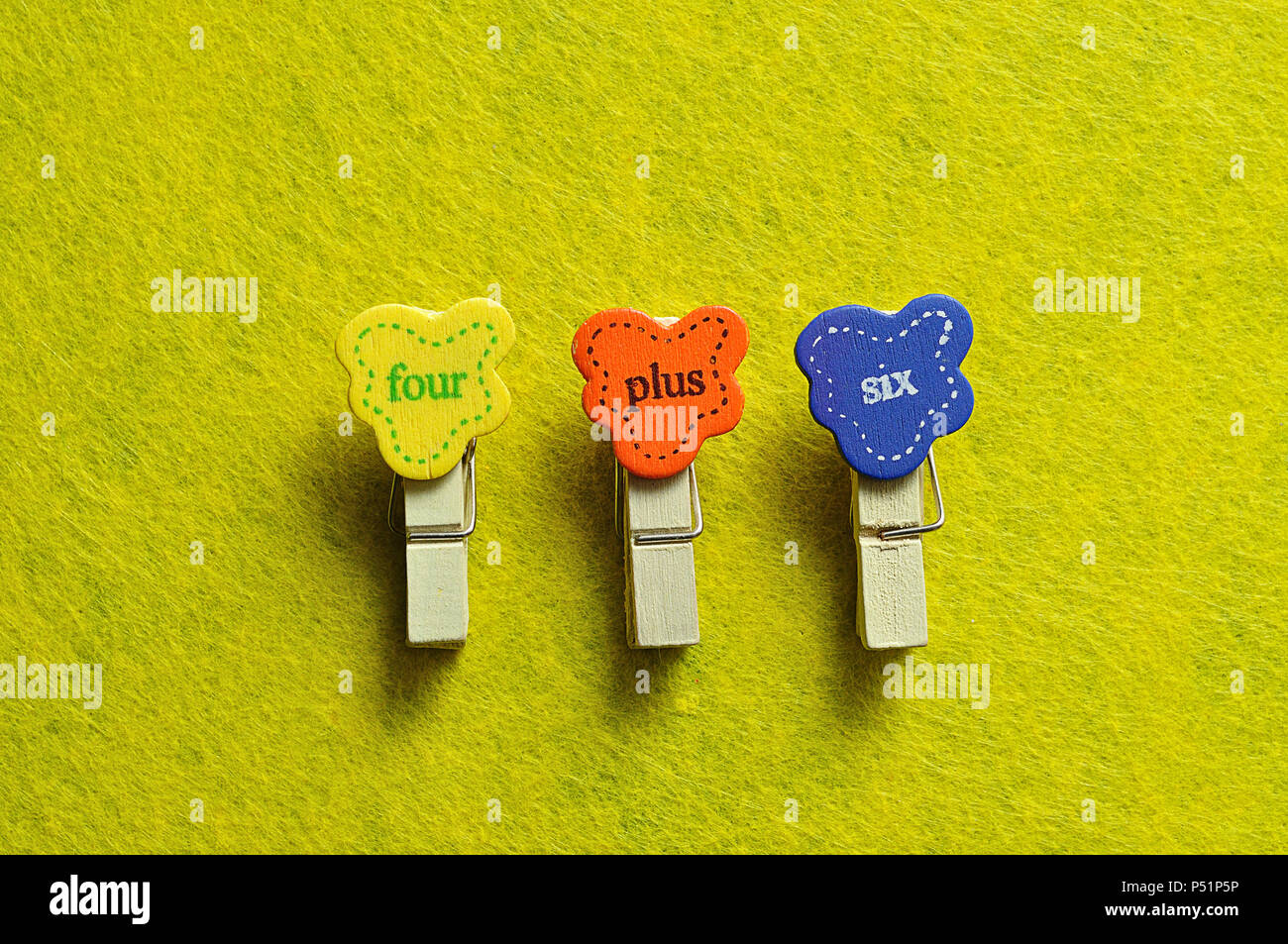 Four plus six on a yellow background Stock Photo - Alamy