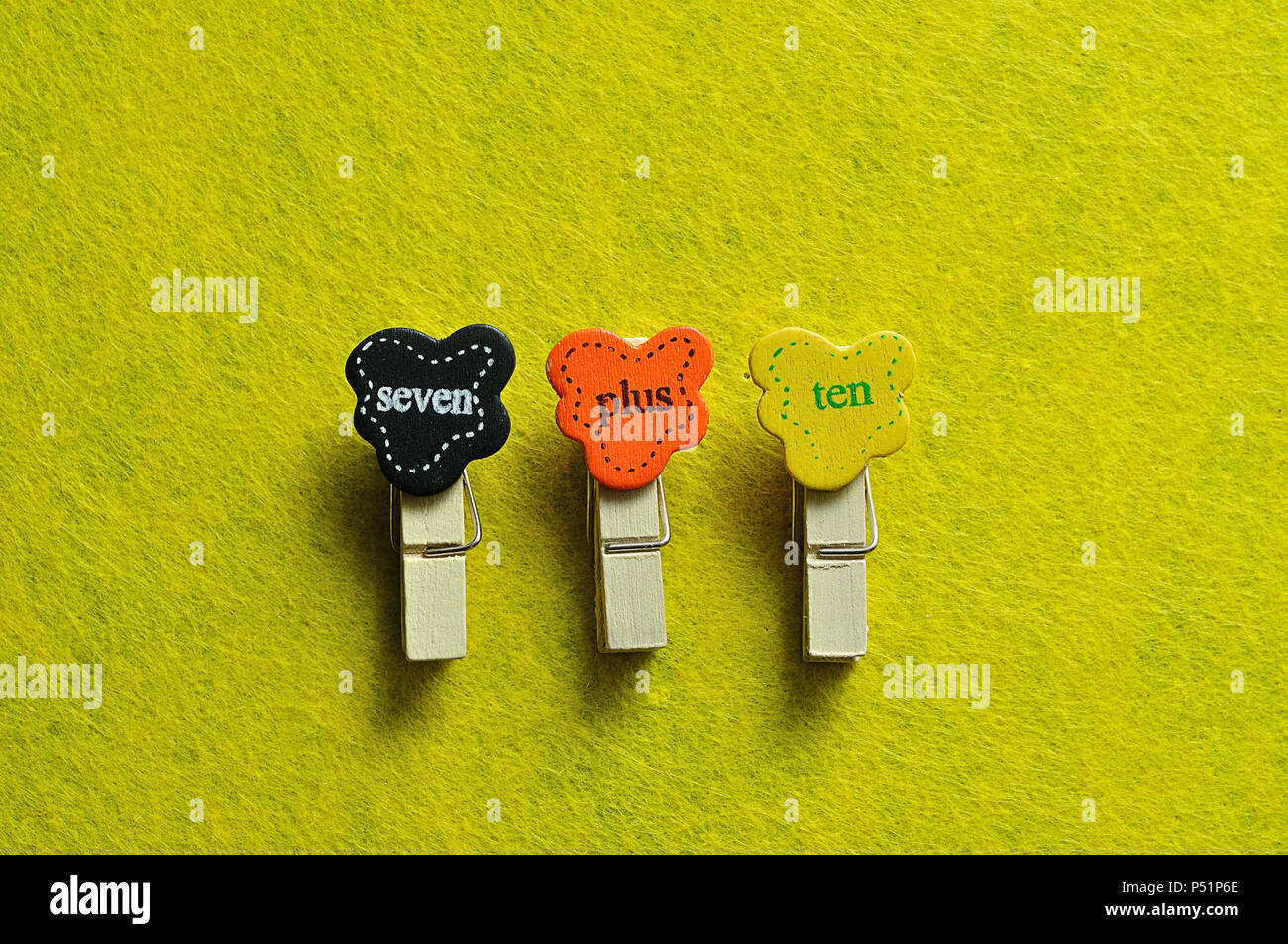 Seven plus ten on a yellow background Stock Photo - Alamy
