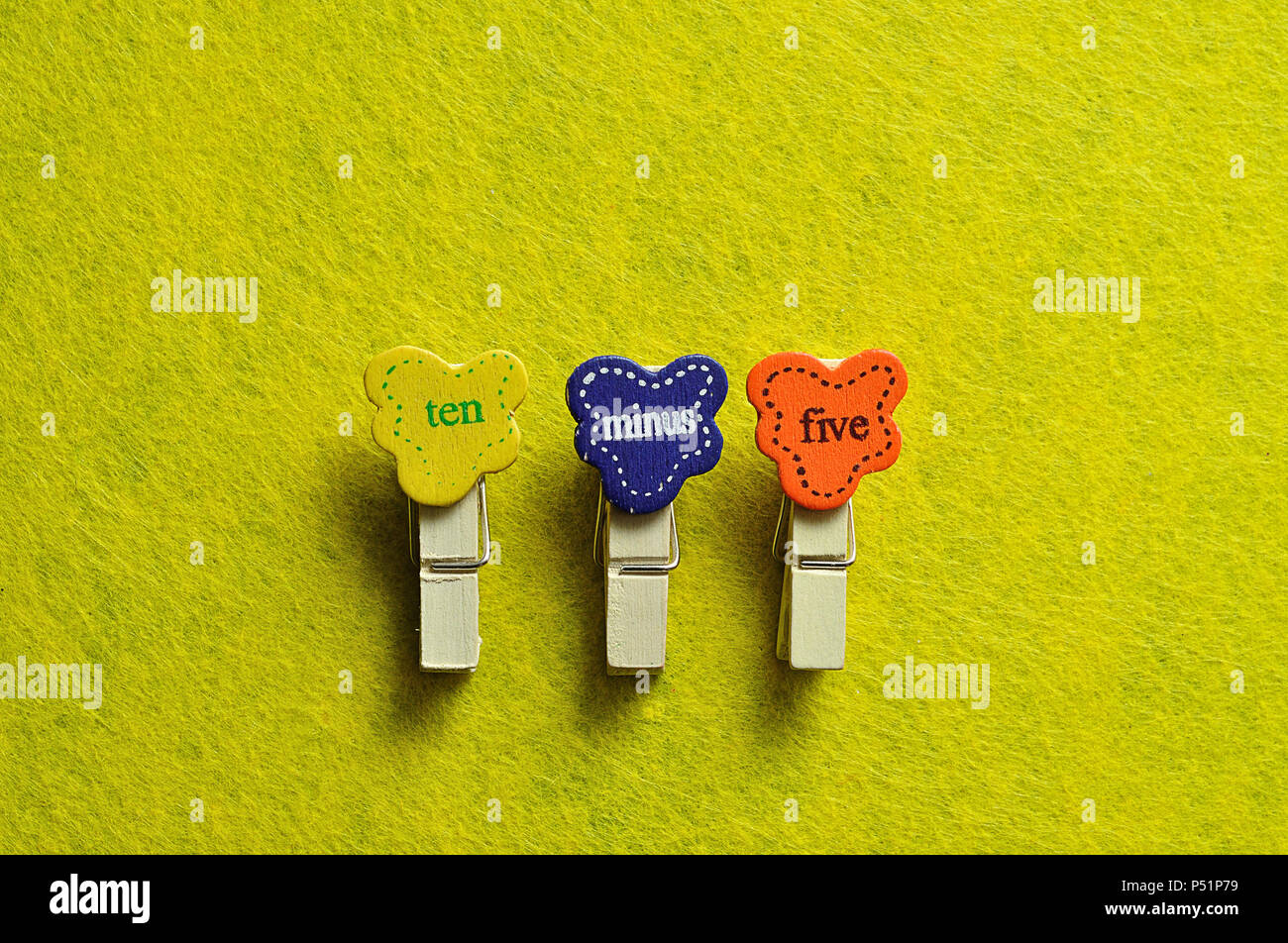 Ten minus five on a yellow background Stock Photo - Alamy