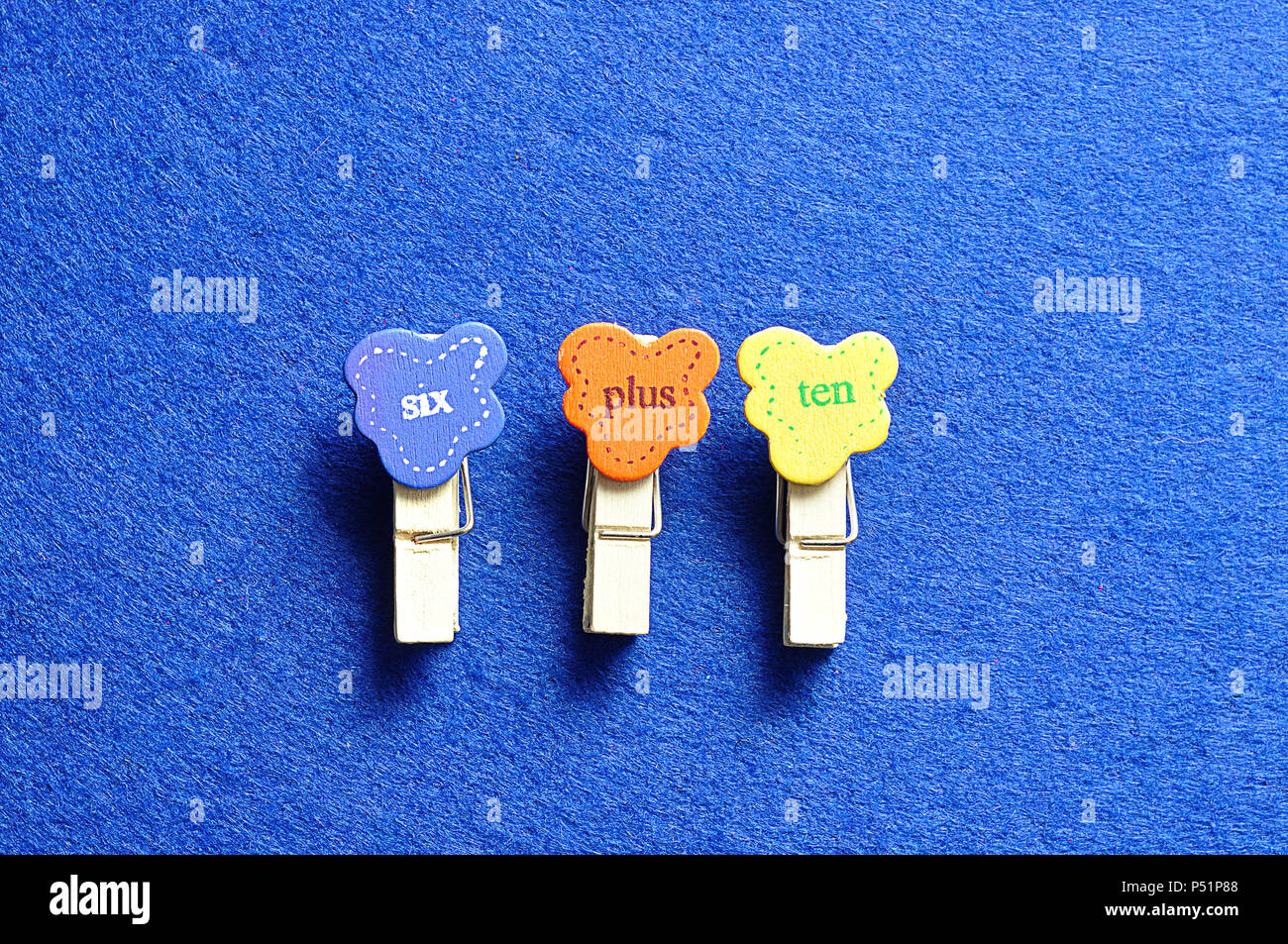 Six plus ten on a blue background Stock Photo - Alamy