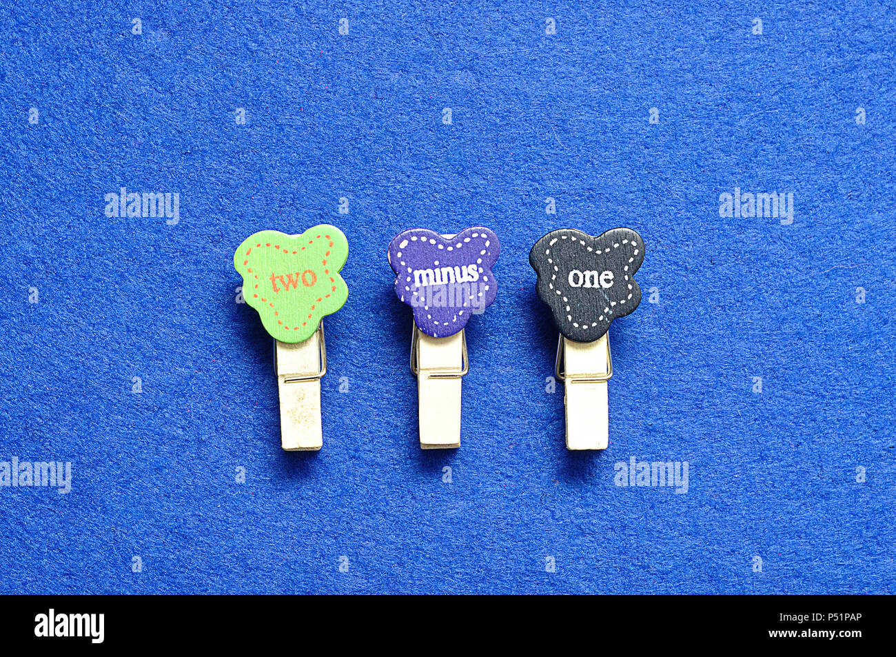 Two minus one on a blue background Stock Photo - Alamy