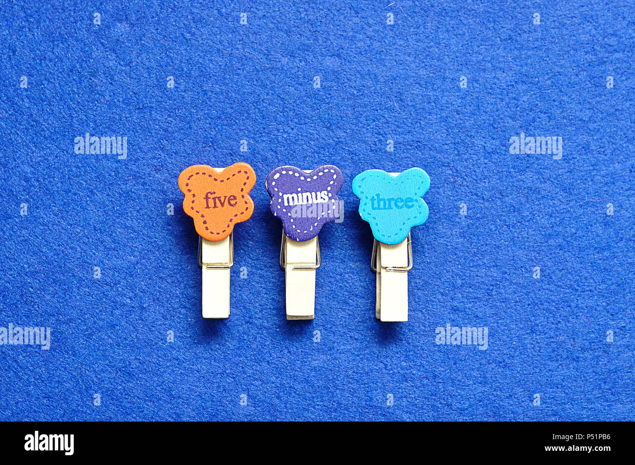 Five minus three on a blue background Stock Photo - Alamy