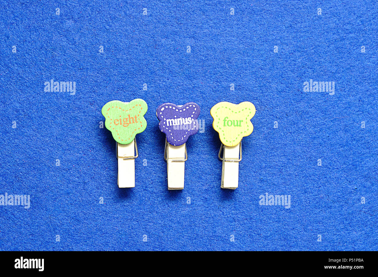 Eight minus four on a blue background Stock Photo - Alamy