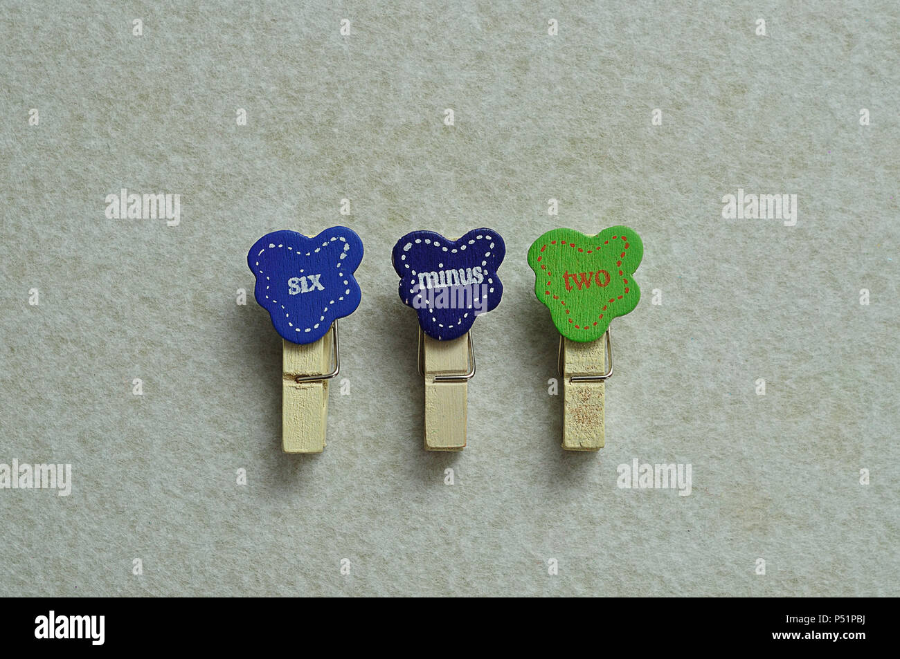 Six minus two on a white background Stock Photo - Alamy