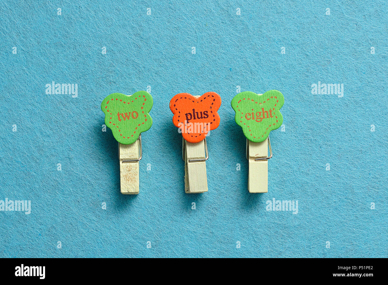 Two plus eight on a blue background Stock Photo - Alamy