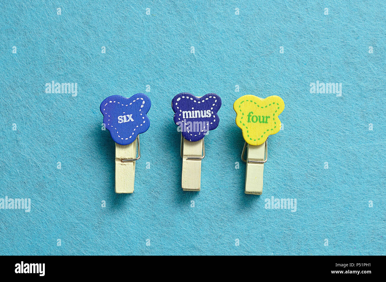 Six minus four on a blue background Stock Photo - Alamy