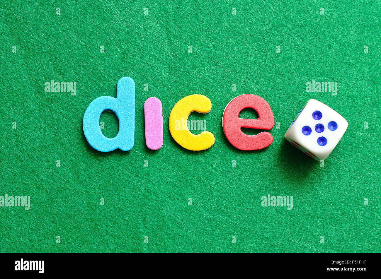 The word dice displayed with a dice on a green background Stock Photo ...