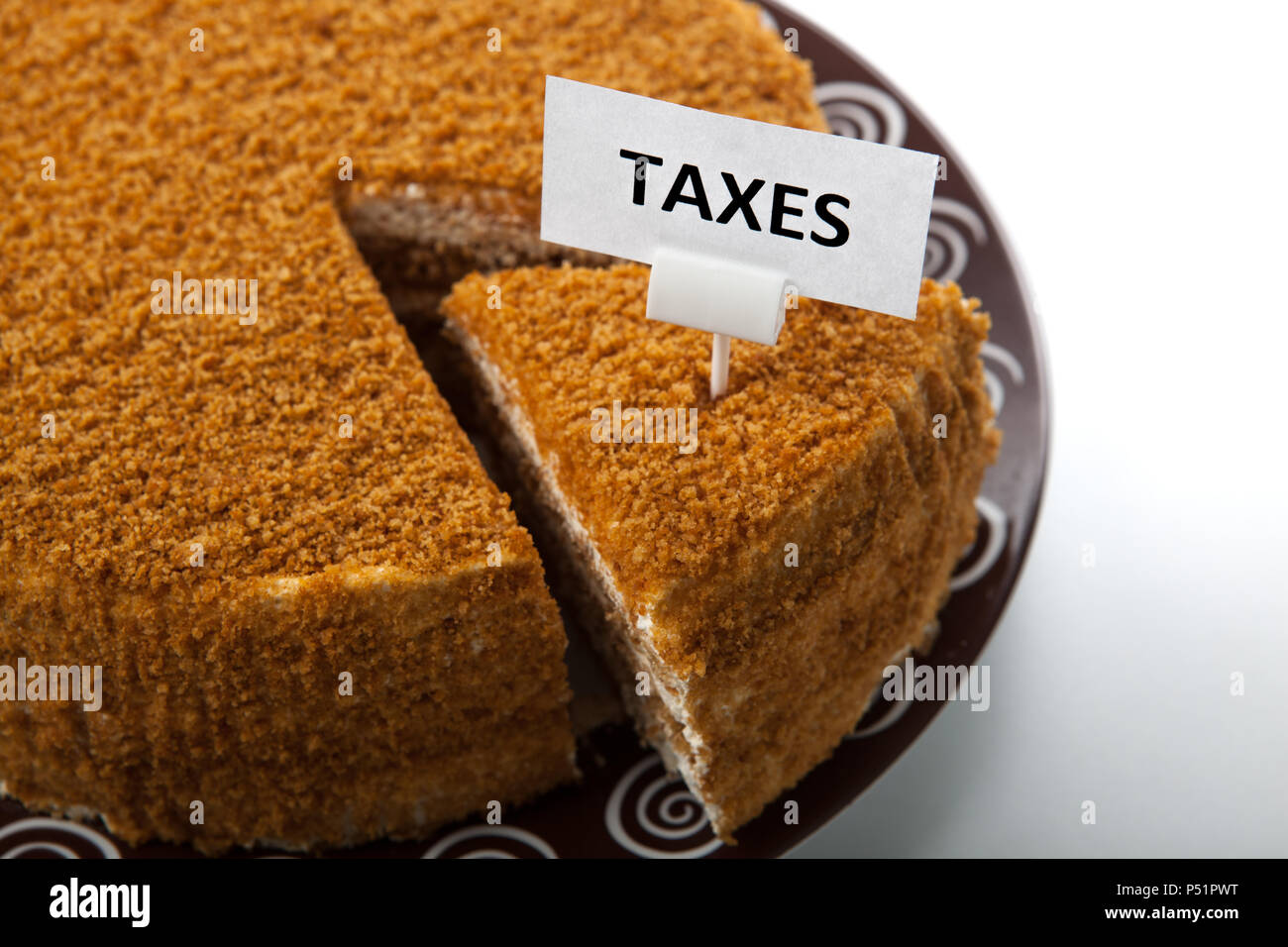 metaphor in the form of cake for the payment of taxes Stock Photo - Alamy