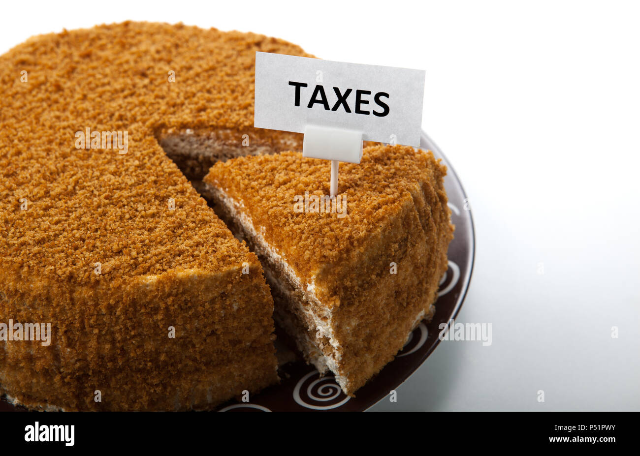 metaphor in the form of cake for the payment of taxes Stock Photo - Alamy