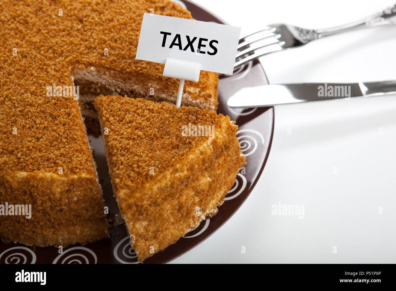 metaphor in the form of cake for the payment of taxes Stock Photo - Alamy