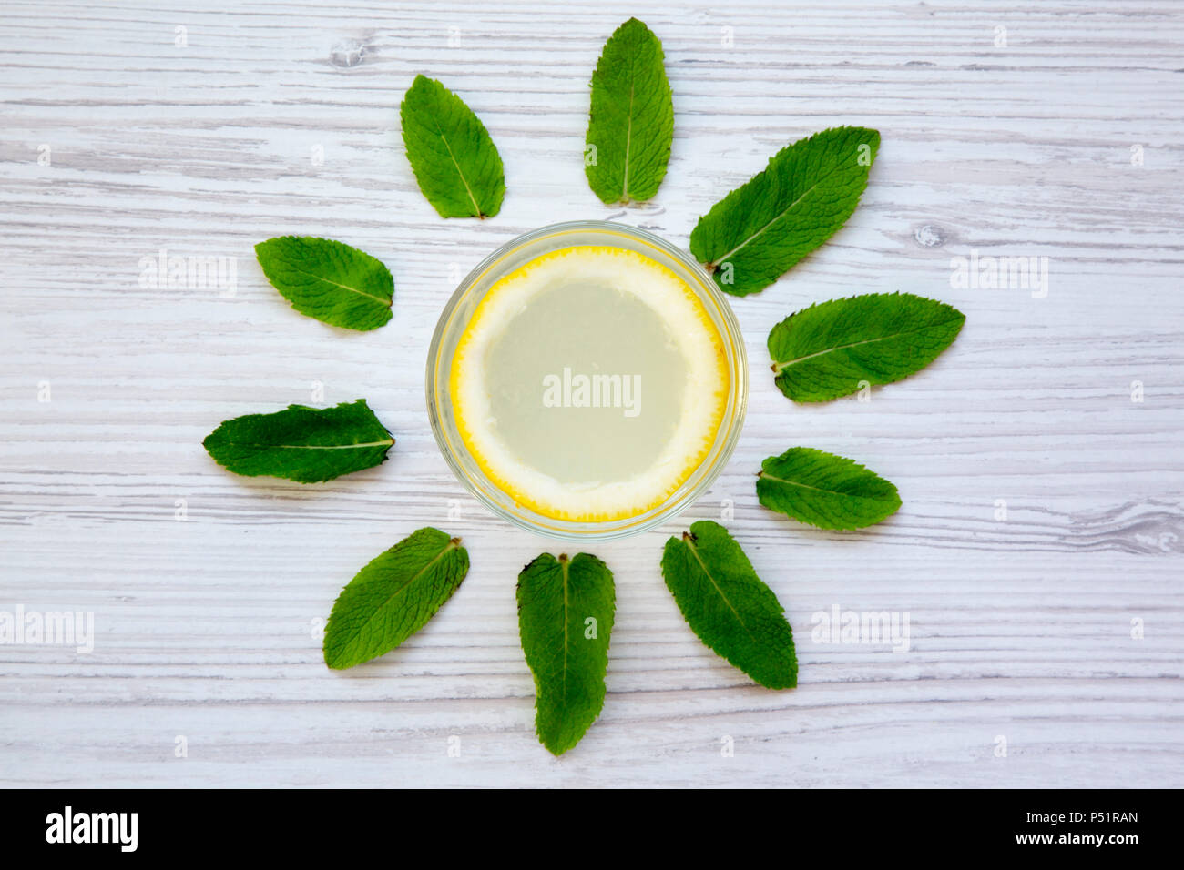 Lemonade drink in a glass on white wooden background, top view ...