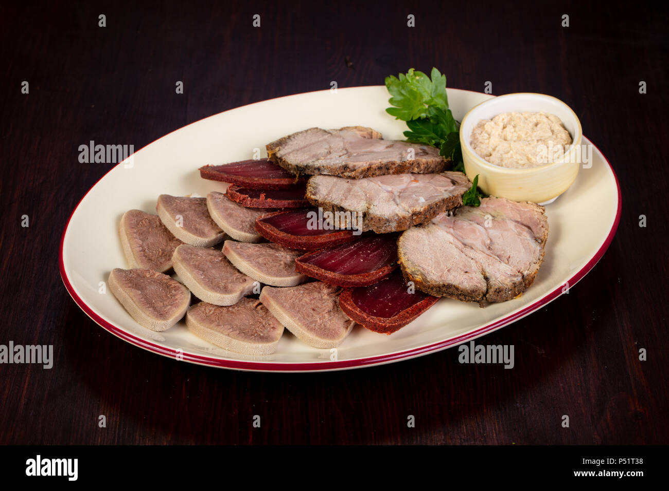 Meat plate mix with tongue and sauce Stock Photo - Alamy