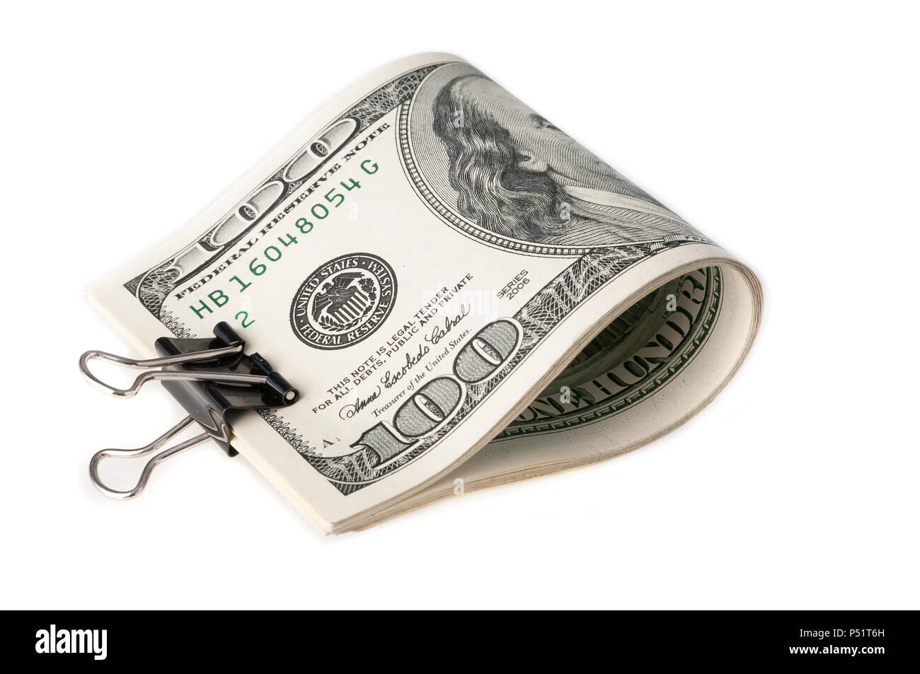 The American dollar bills are folded and clamped with a paper clip. on ...
