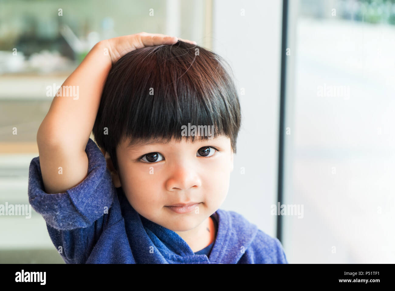 Kid touching hair hi-res stock photography and images - Alamy