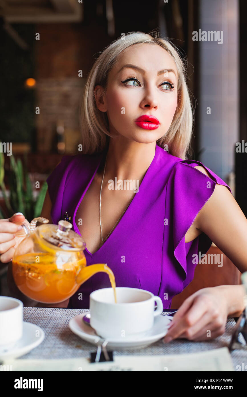 Pretty Model Woman drinking herbal tea in restaurant Stock Photo - Alamy