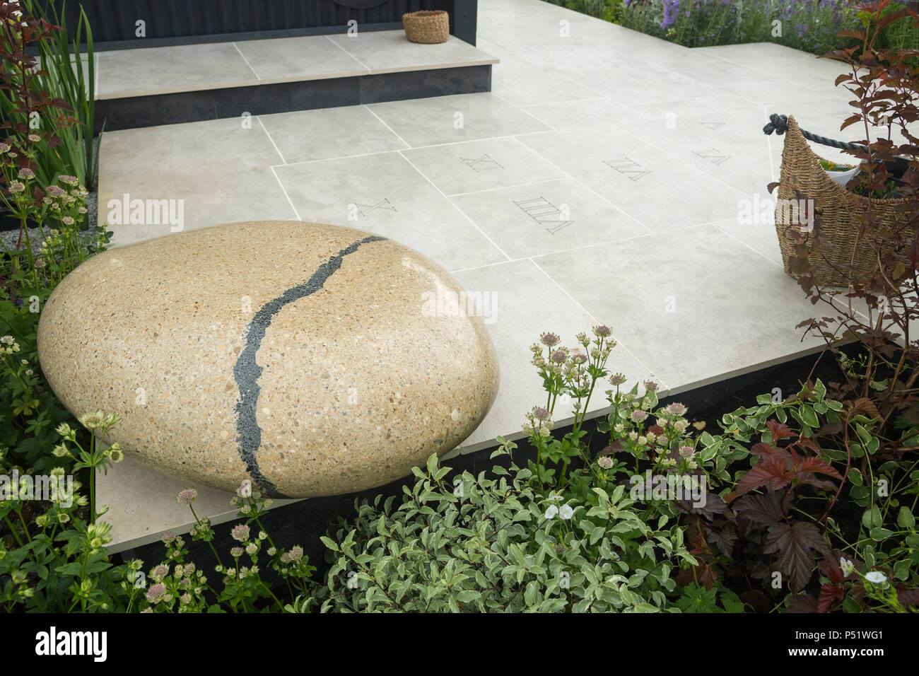 Close-up of stone garden feature, plants & paving - CCLA : A Family ...