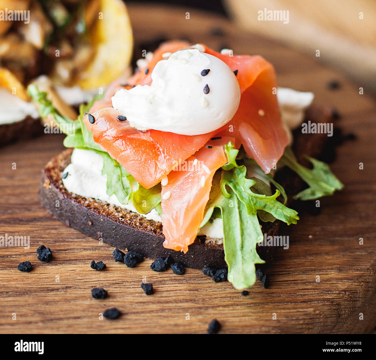 Danish Smorrebrod with red salmon fish and egg on wooden board Stock ...