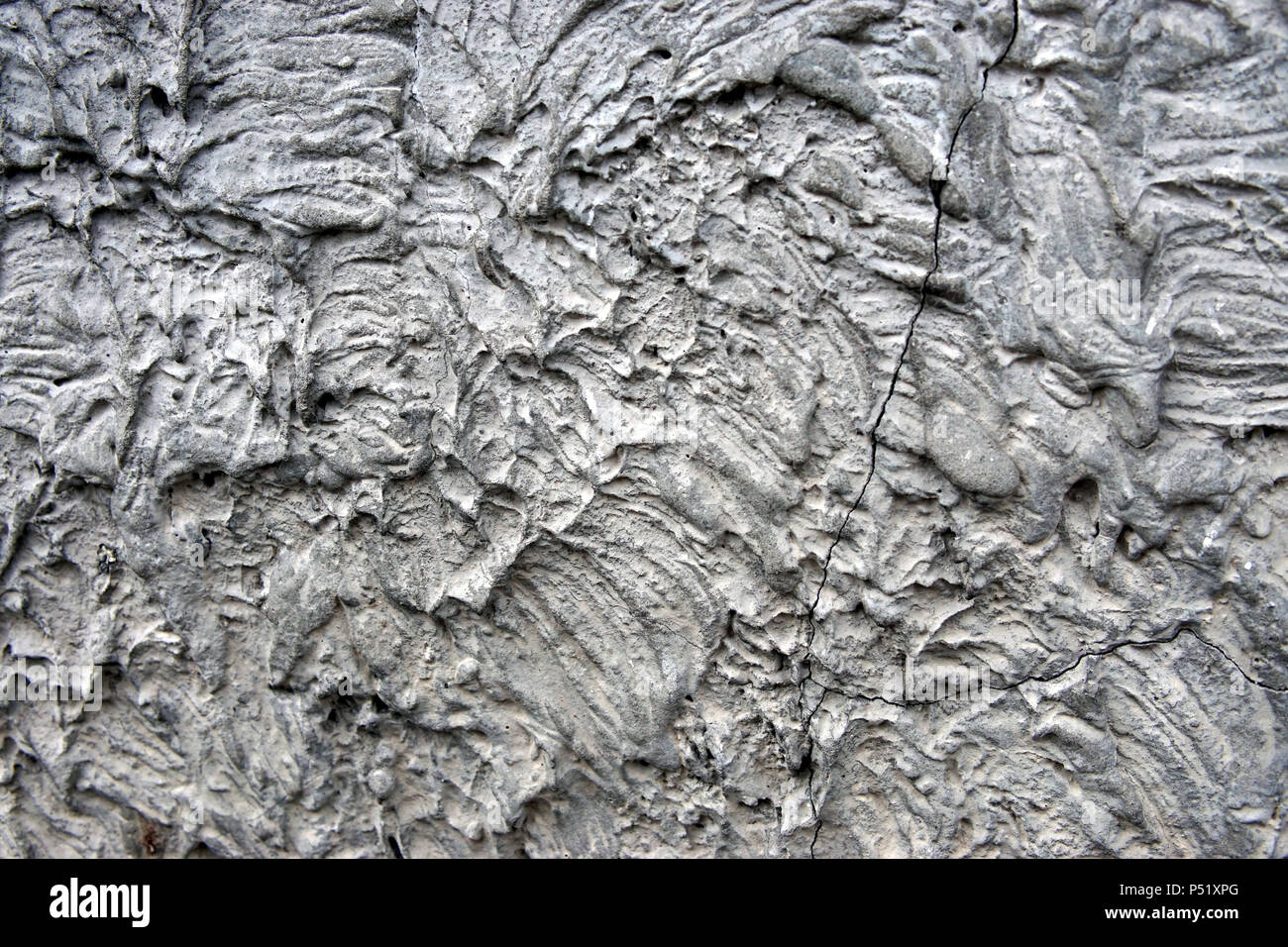A stone wall covered in plaster macro Stock Photo - Alamy
