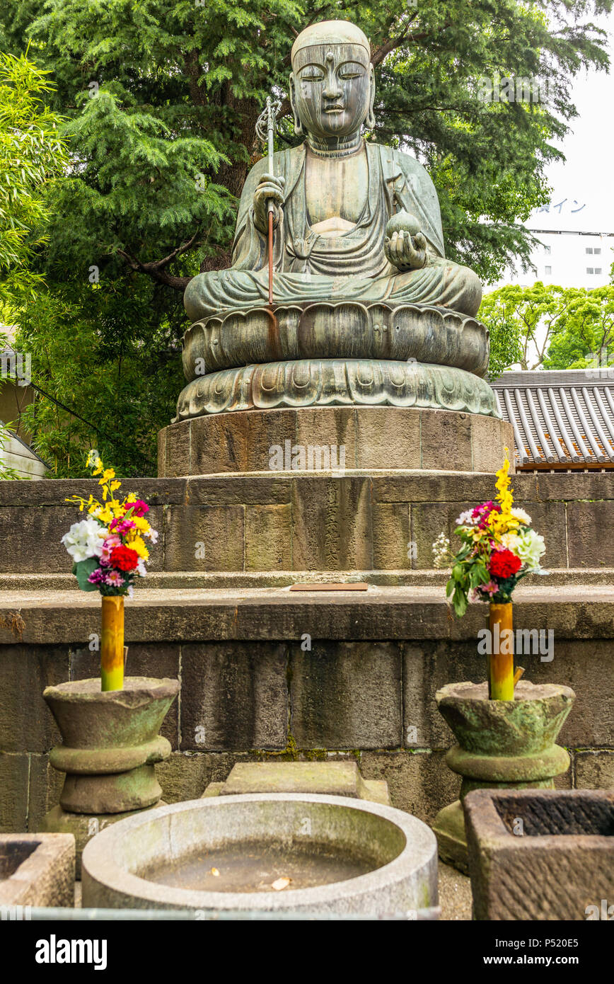 Stone Buddha statue in a Shintoist shrine in Tokyo - 1 Stock Photo - Alamy