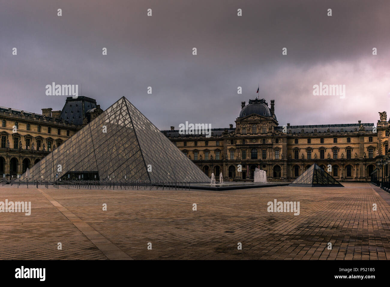The square of the Louvre museum in Paris early in the morning Stock ...