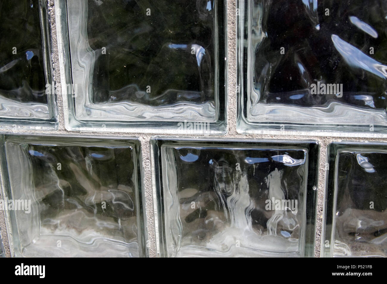 A wall of glass blocks with a dark behind them Stock Photo - Alamy