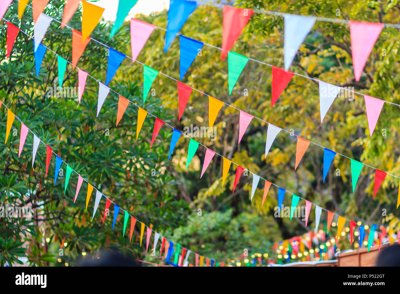 The colorful flags between the trees in Thai style temple festival ...