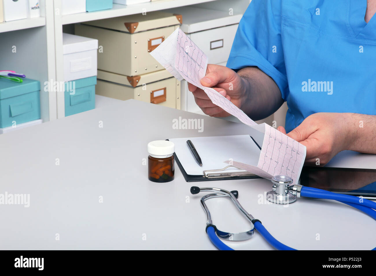 Close-up of doctor's hands writing prescription and holding bottle with ...