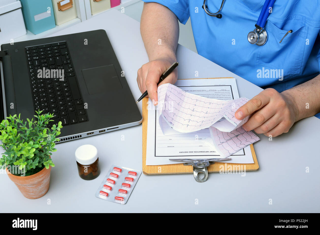 Close-up of doctor's hands writing prescription and holding bottle with ...