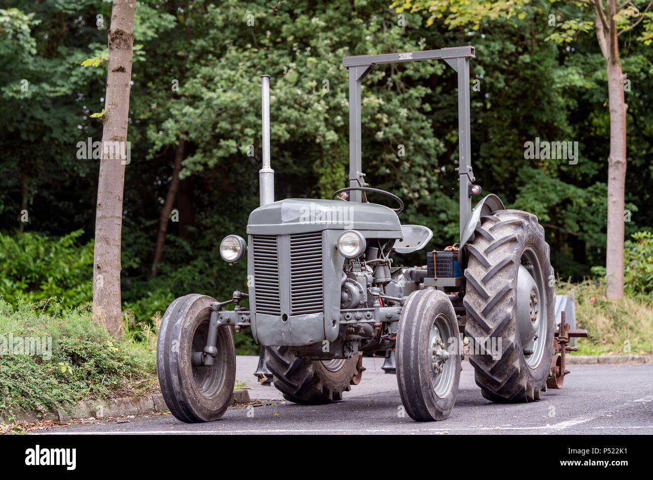 A very old grey tractor on a road Stock Photo - Alamy