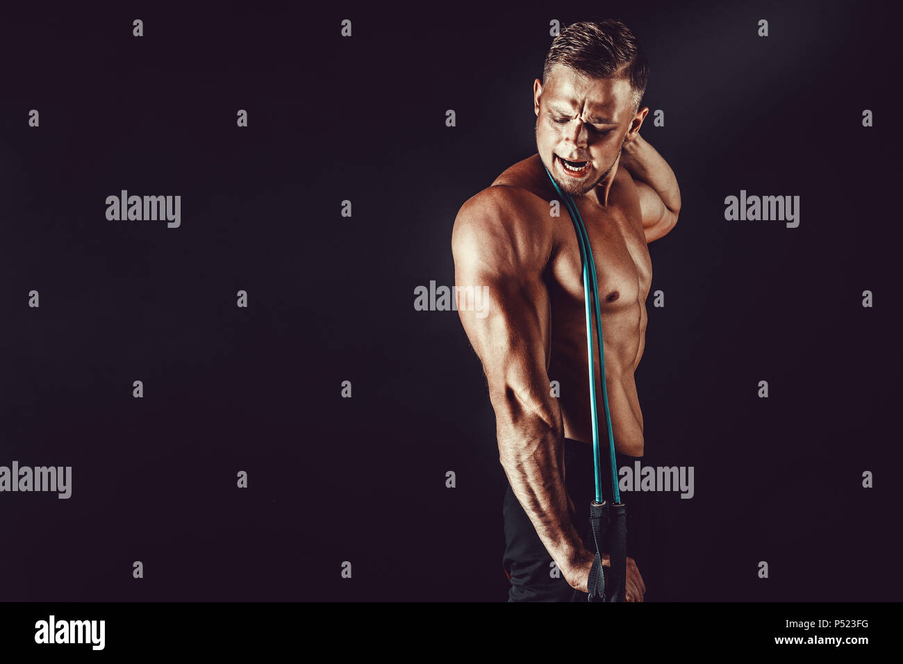 Fitness man exercising with stretching band. Muscular sports man ...