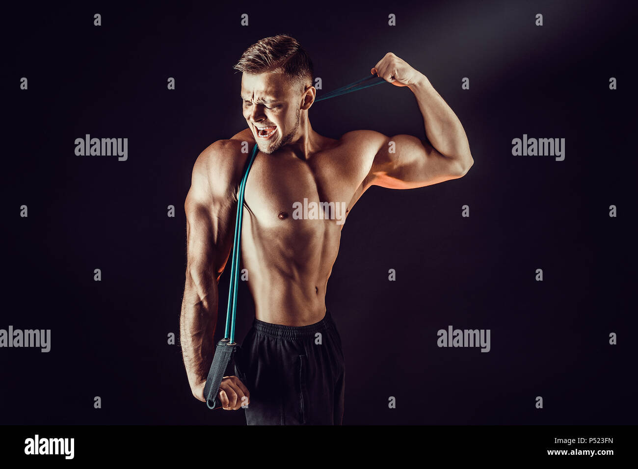 Fitness man exercising with stretching band. Muscular sports man ...