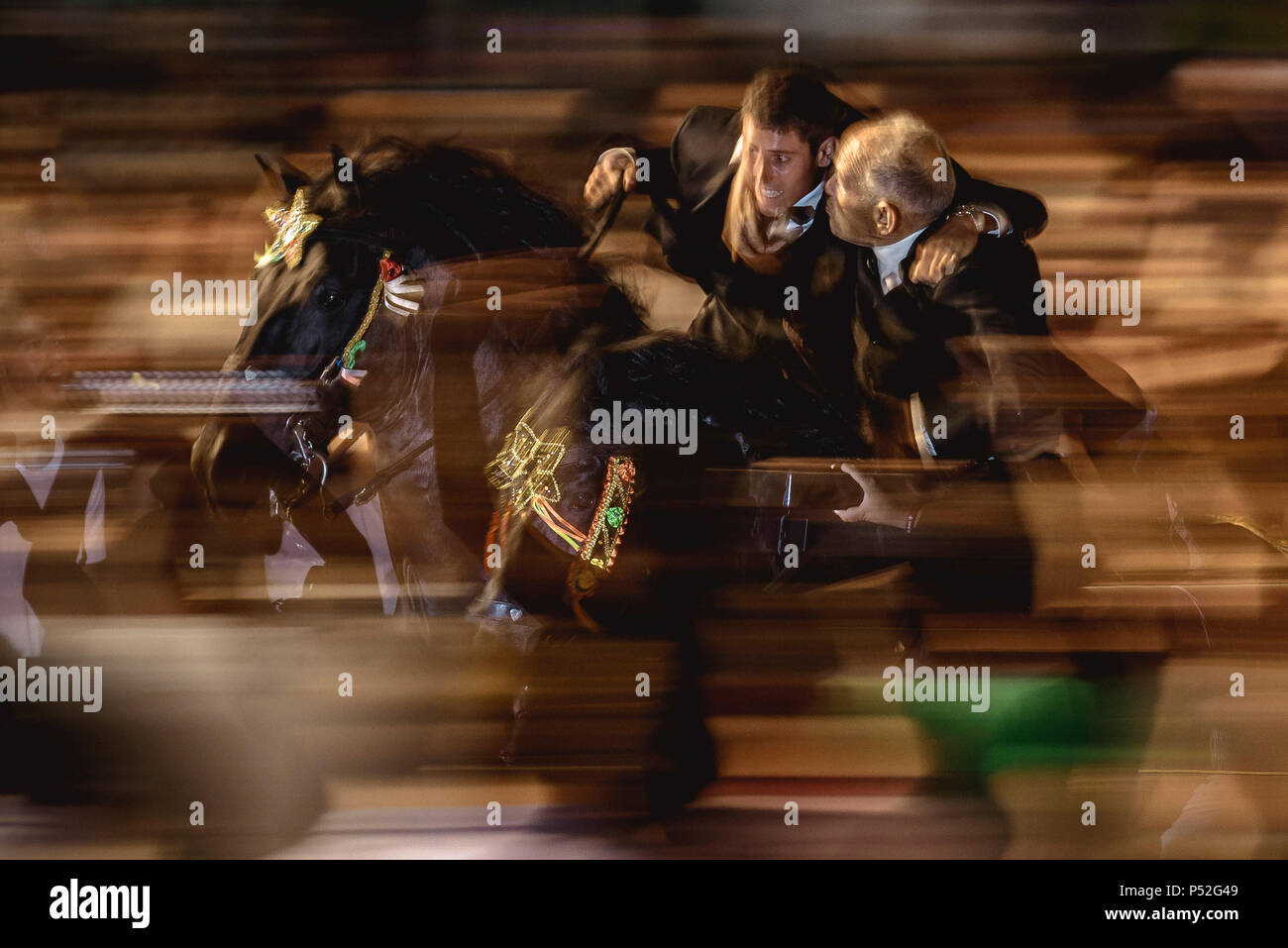 Ciutadella, Spain. 24 June, 2018: Two 'caixers' (horse riders) gallop ...
