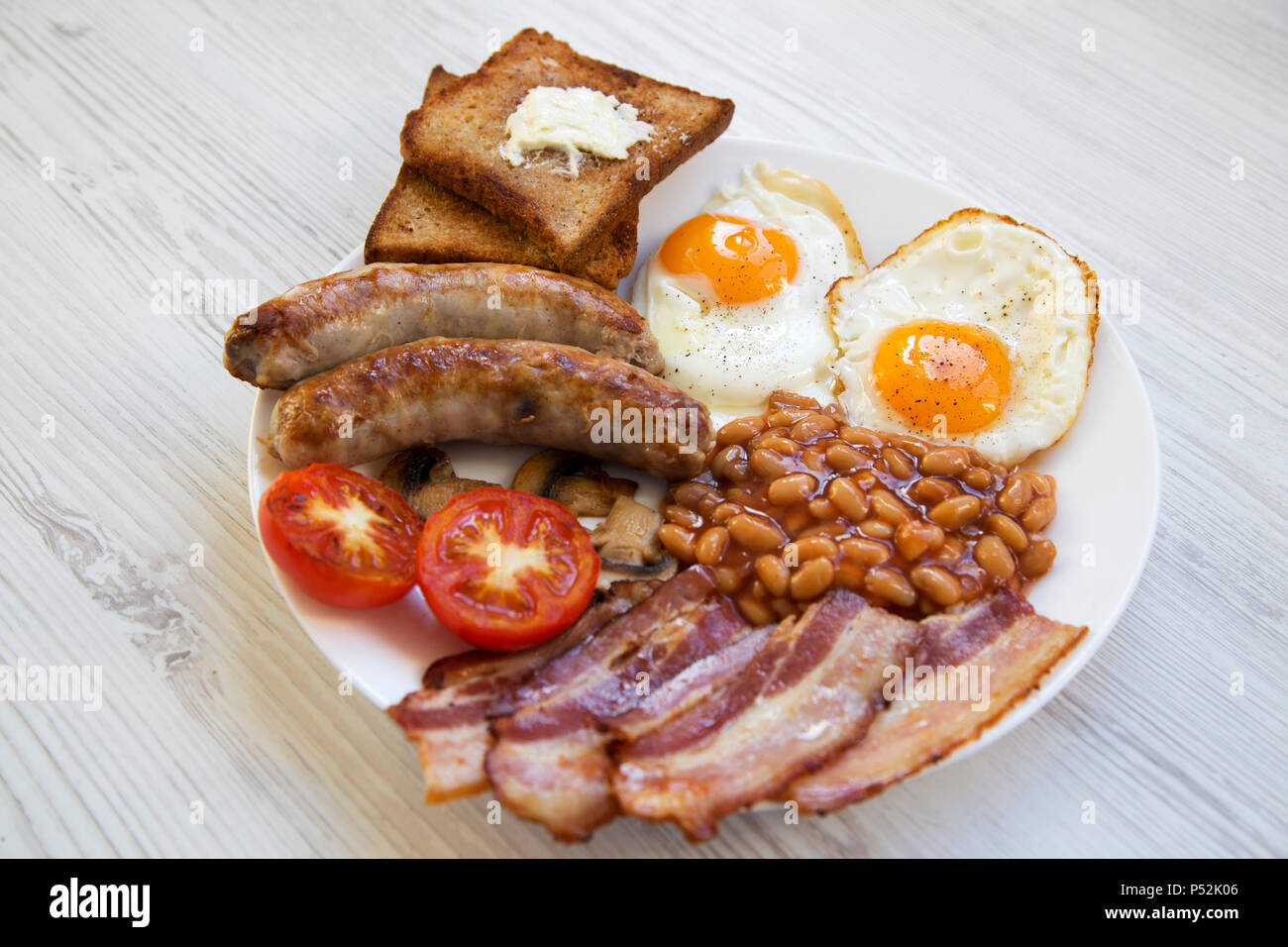 English breakfast on a white wooden background, closeup. Side view ...