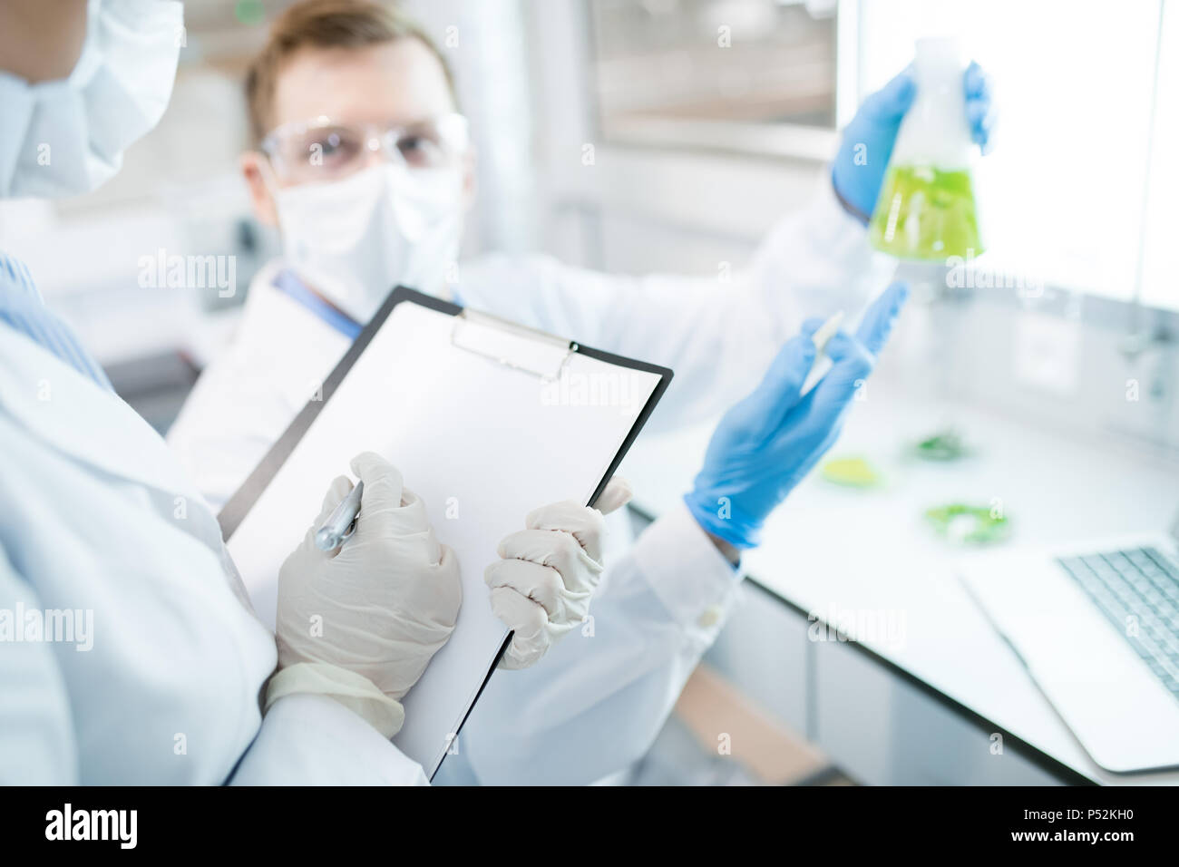 Scientists writing results of food nutrition tests Stock Photo - Alamy