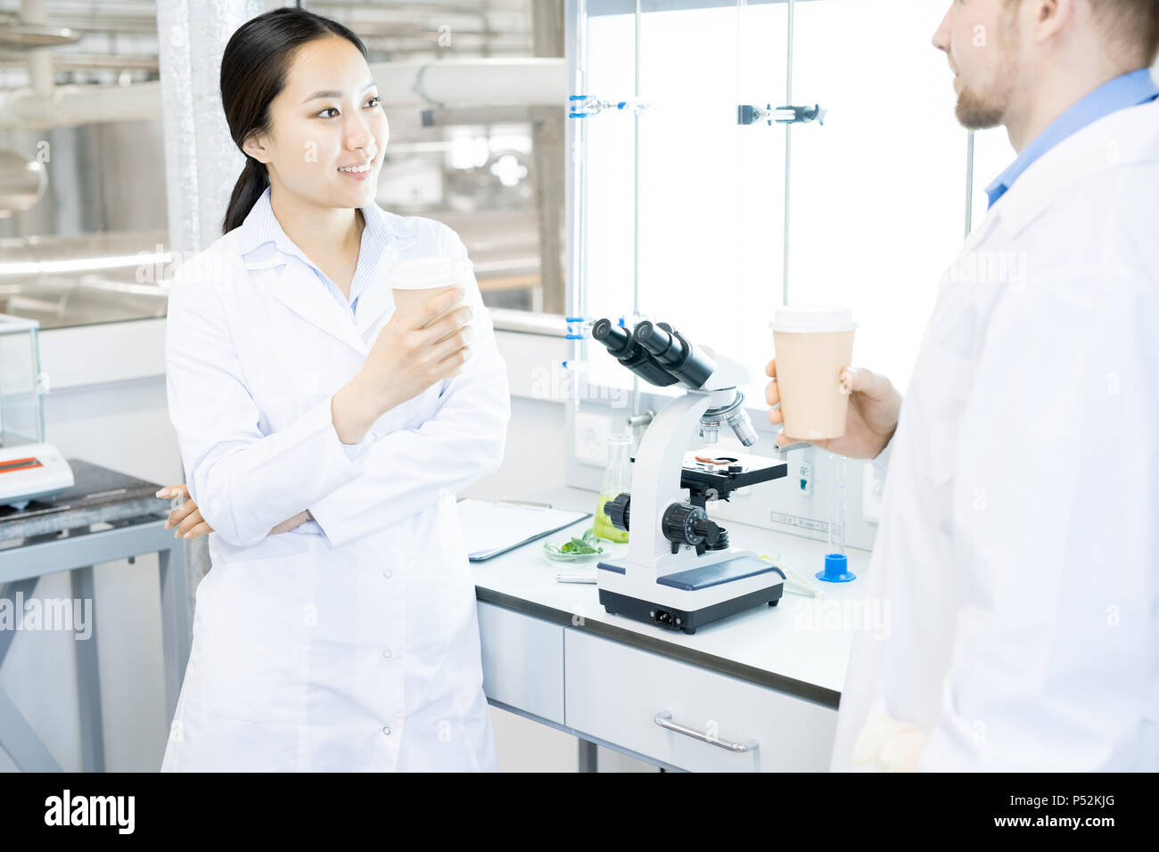 Scientists resting in laboratory with drinks Stock Photo - Alamy