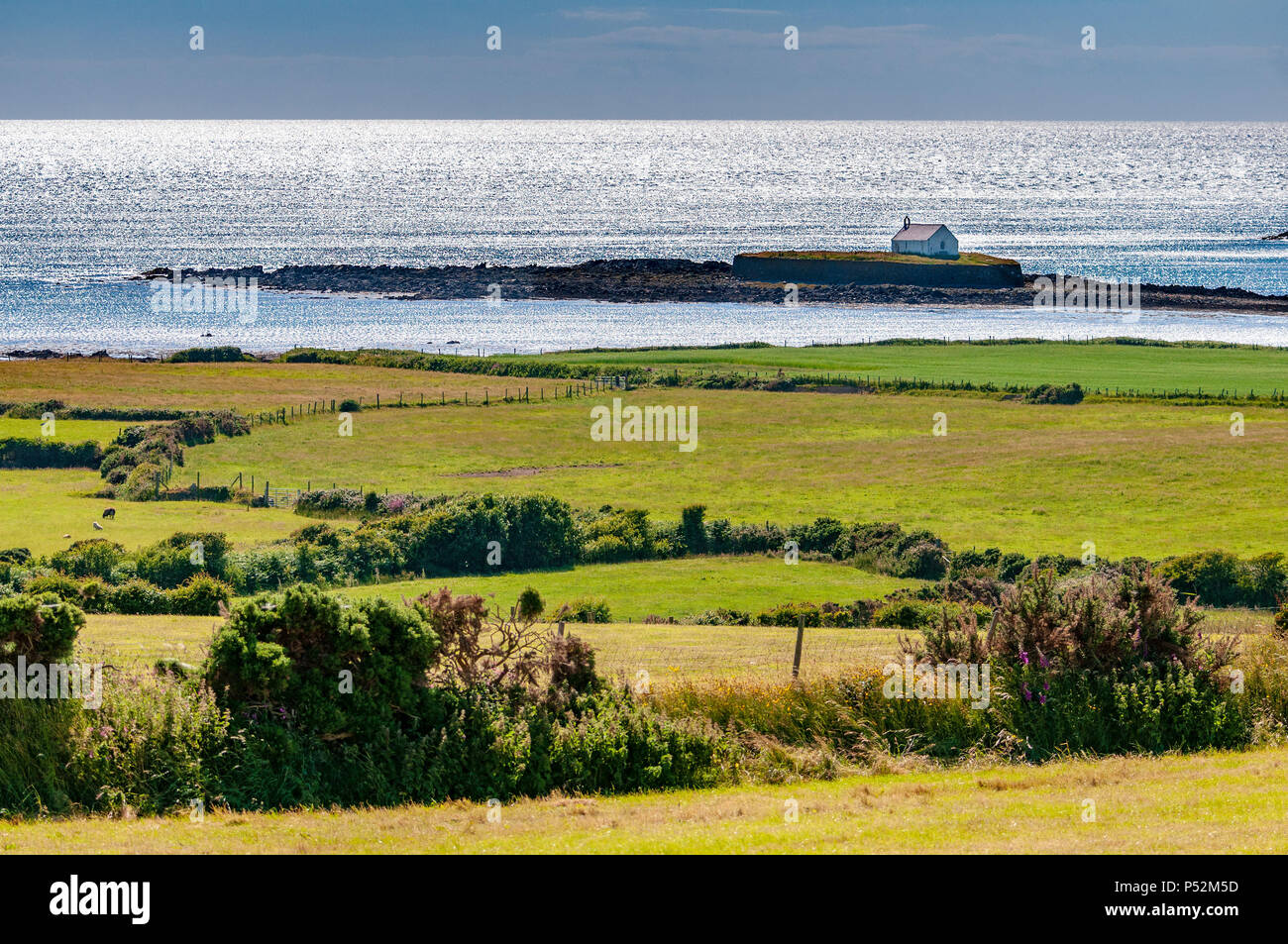 North Wales. Cwyfan Church on its tidal island of Cribinau Anglesey ...