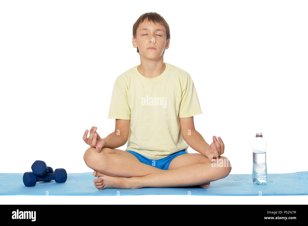 Young boy practicing yoga isolated Stock Photo - Alamy