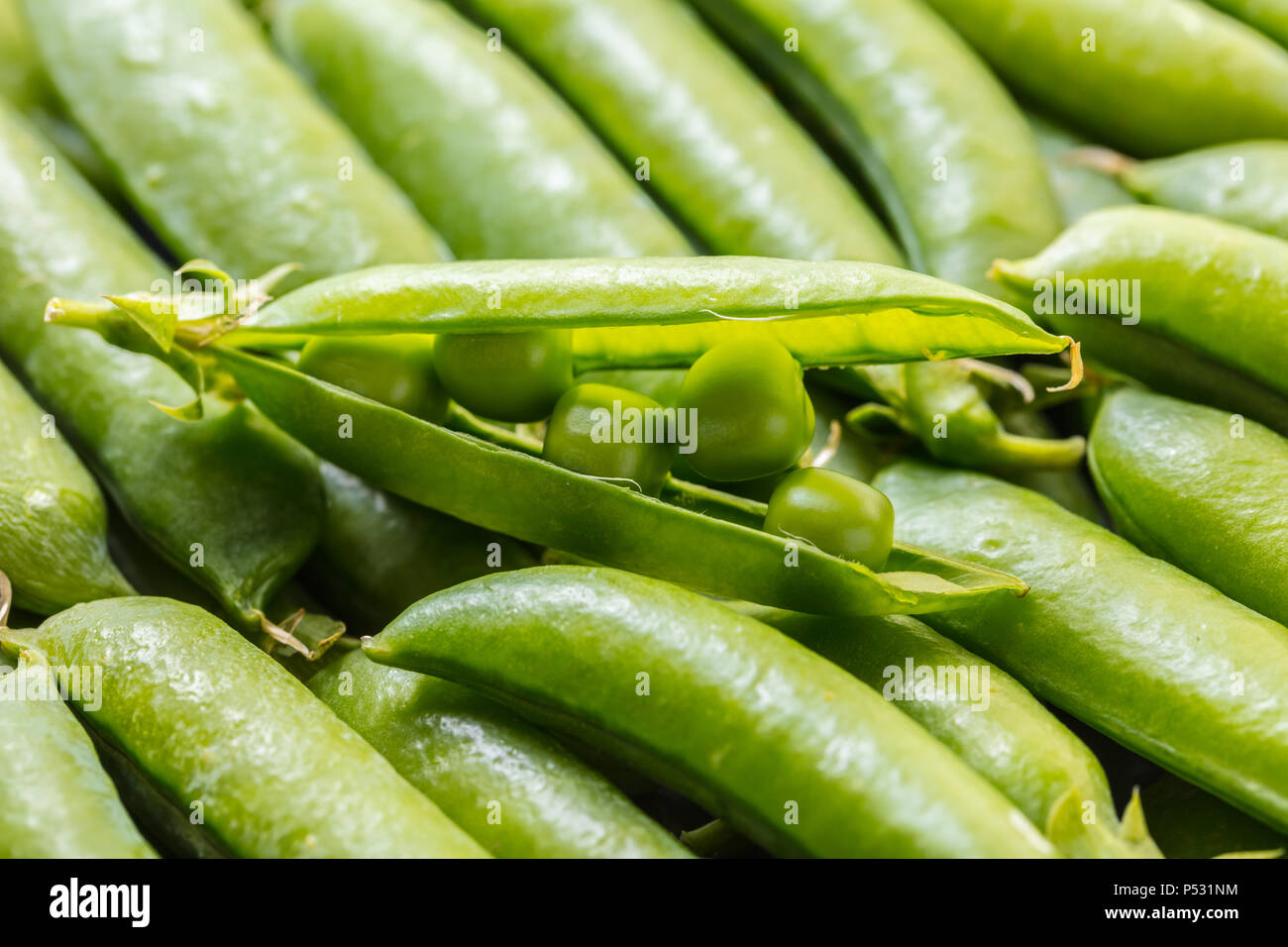 food background of a texture of green peas pods Stock Photo - Alamy
