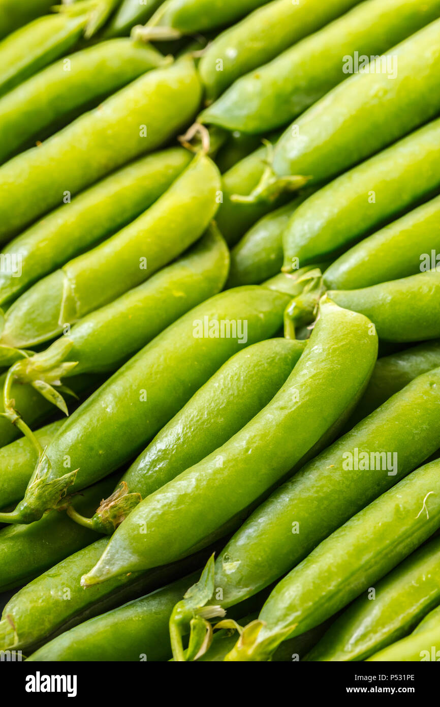 food background of a texture of green peas pods Stock Photo - Alamy
