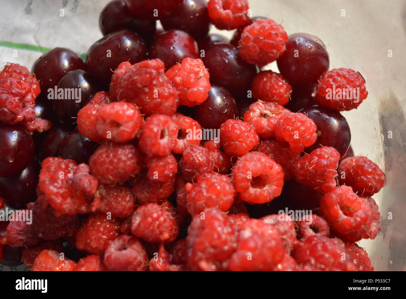 Produce, fresh fruits, red homemade raspberries, cherries arranged in a ...