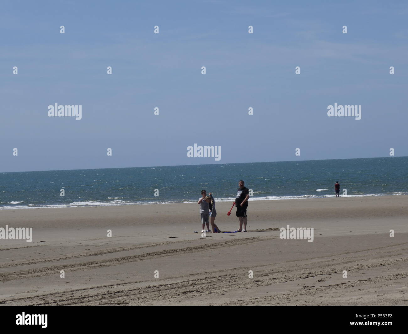 people on the beach on a sunny day Stock Photo - Alamy